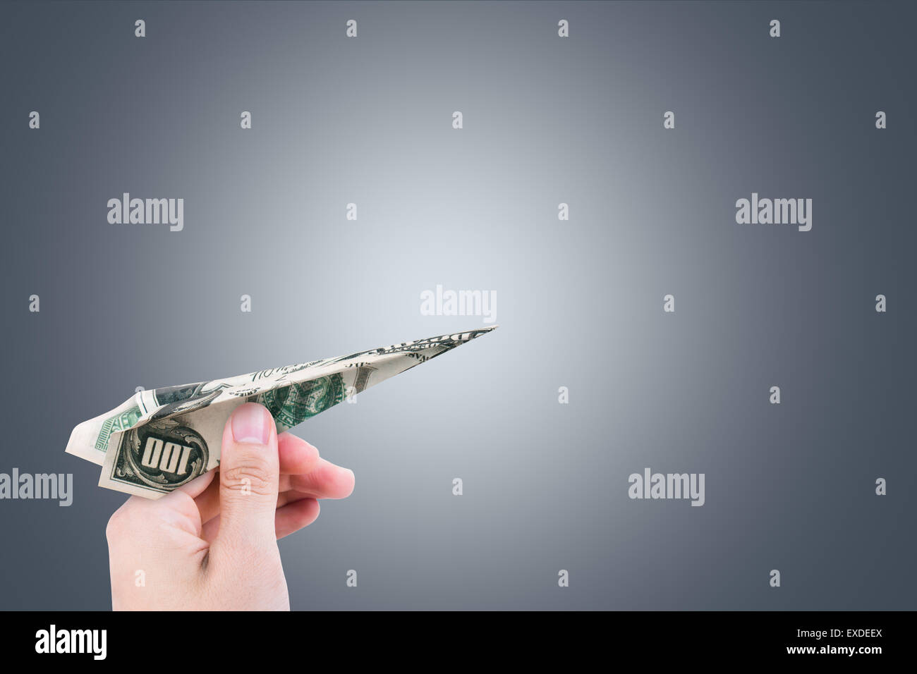 Flying paper plane with dollar banknote holding in hand, on grey ...