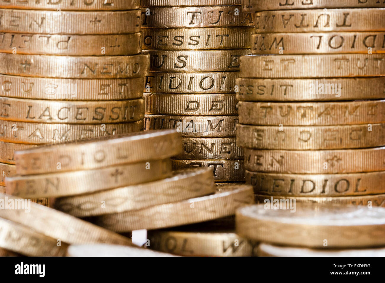 Columns of British £1, one pound, coins stacked up showing lettering on ...