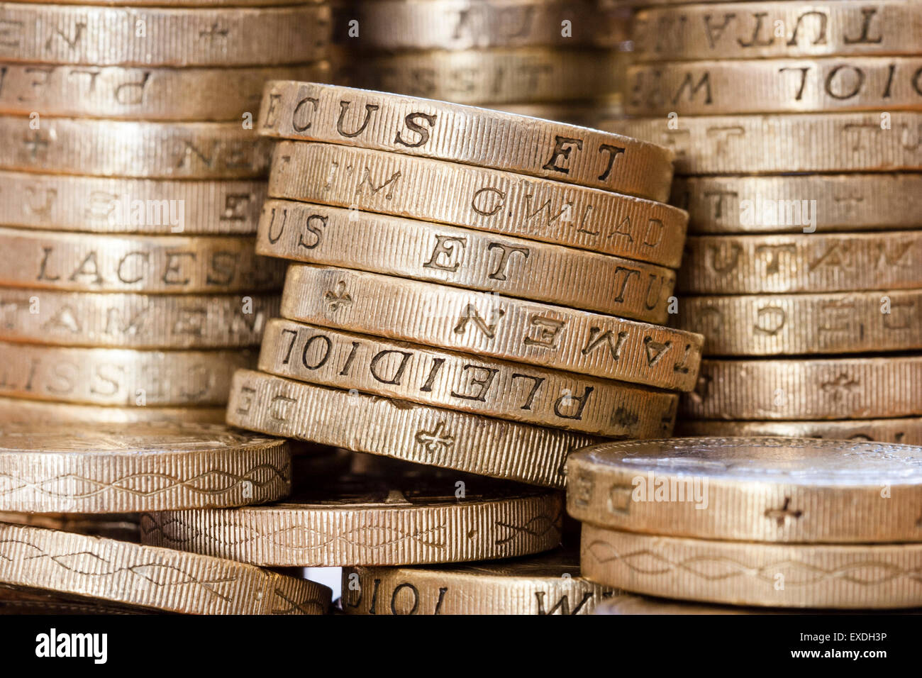 Columns of British £1, one pound, coins stacked up showing lettering on ...