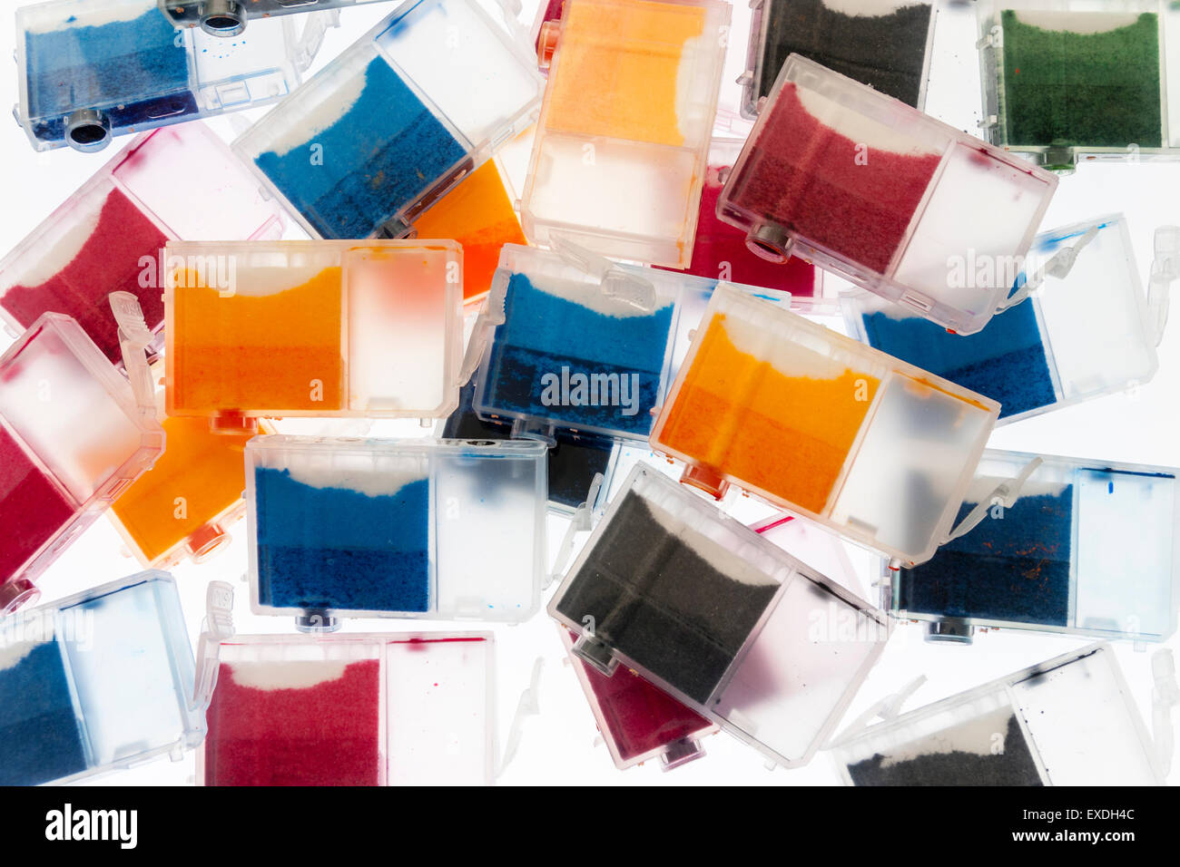 Scattered home printing empty used ink jet cartridges against back-lit ...