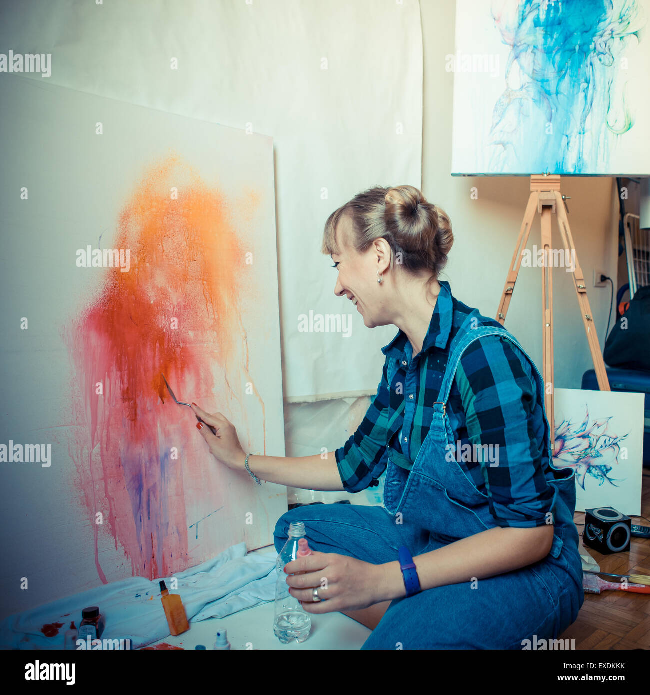 beautiful blonde woman painter in her studio Stock Photo - Alamy