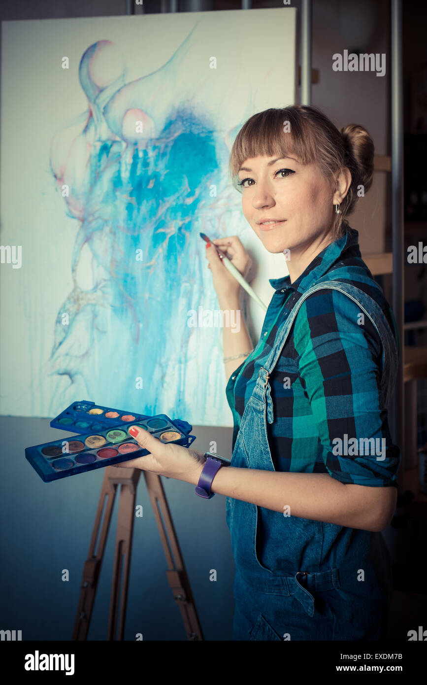 beautiful blonde woman painter in her studio Stock Photo - Alamy