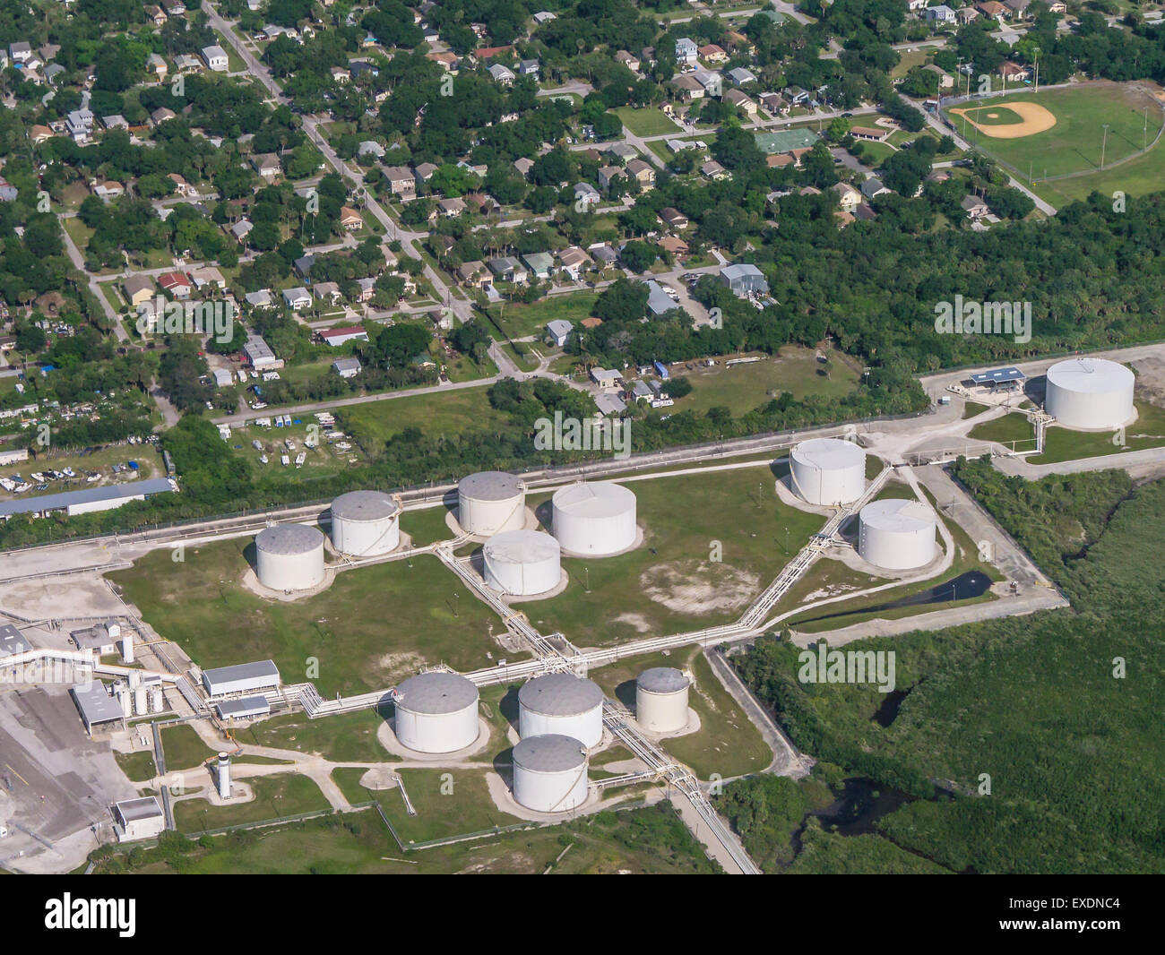 Aerials of industrial storage tank complex close to houses in Tampa ...