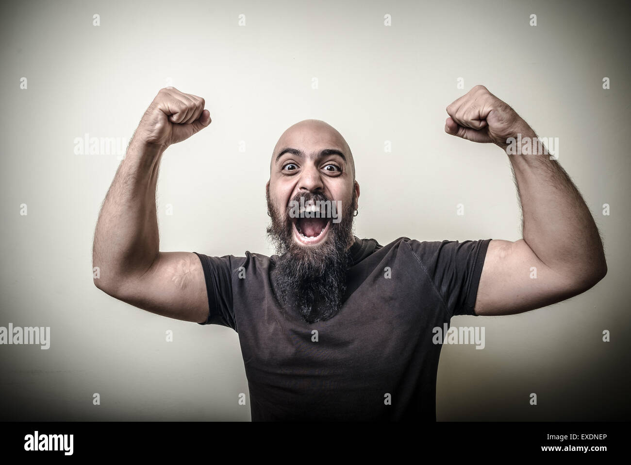 strong winner bearded man isolated on gray background Stock Photo - Alamy