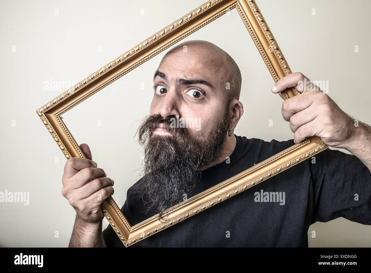 funny bearded man with golden frame on gray background Stock Photo - Alamy