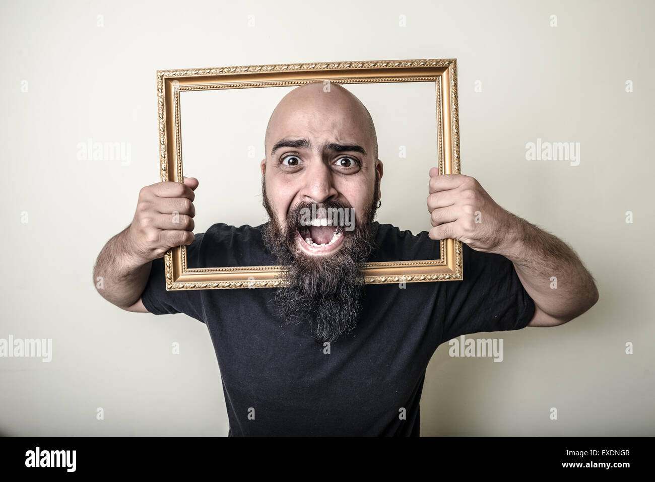 funny bearded man with golden frame on gray background Stock Photo - Alamy