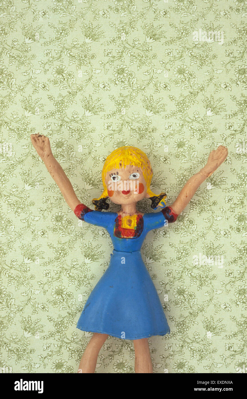 Bendy rubber girl doll with blue dress and innocent expression standing ...