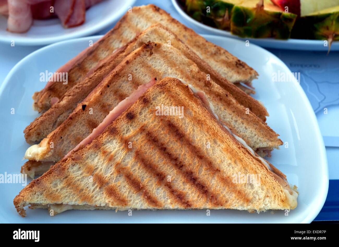 Cheese and ham toasties on a blue plate Stock Photo - Alamy