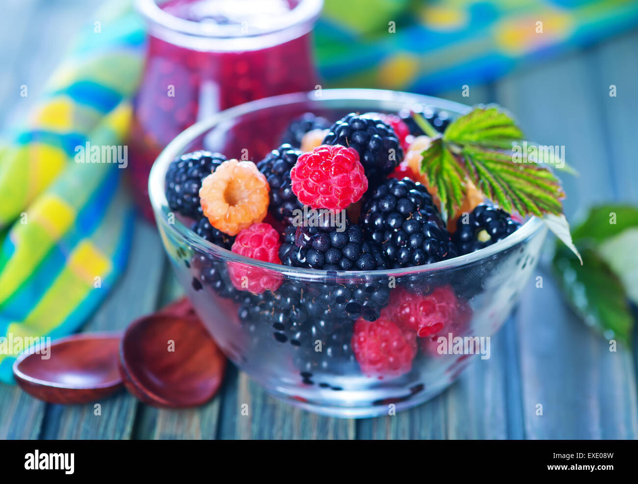 fresh berries in glass bowl and on a table Stock Photo - Alamy