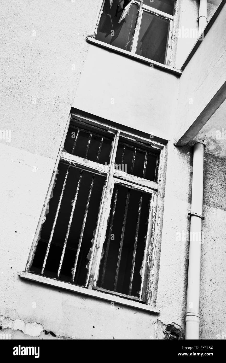 A broken window in a derelict building Stock Photo - Alamy