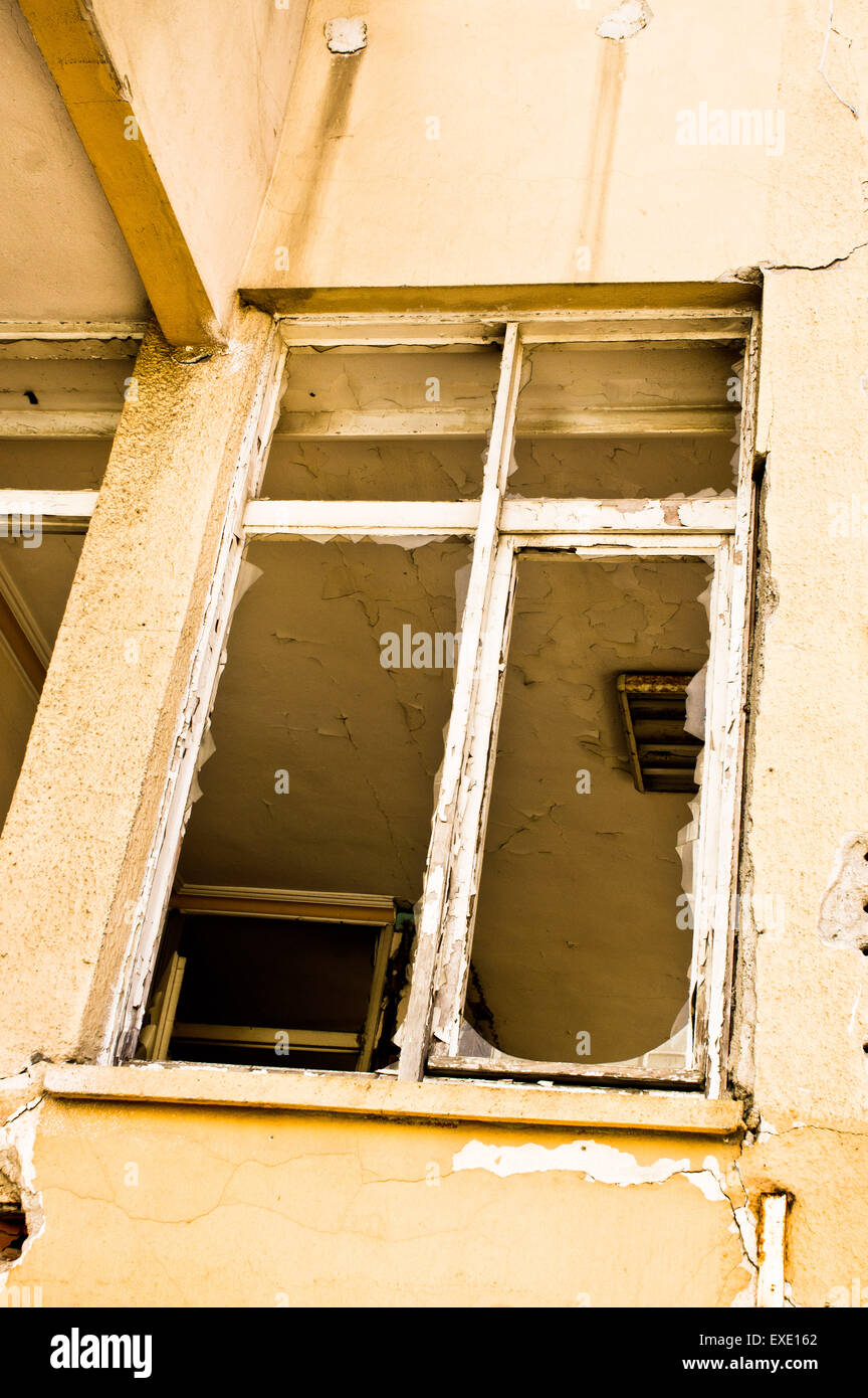 A broken window in a derelict building Stock Photo - Alamy
