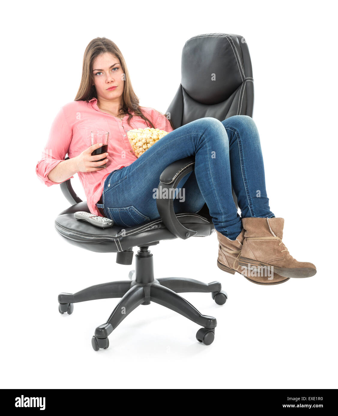 Lazy woman sitting stretched out in an armchair with popcorn and a ...