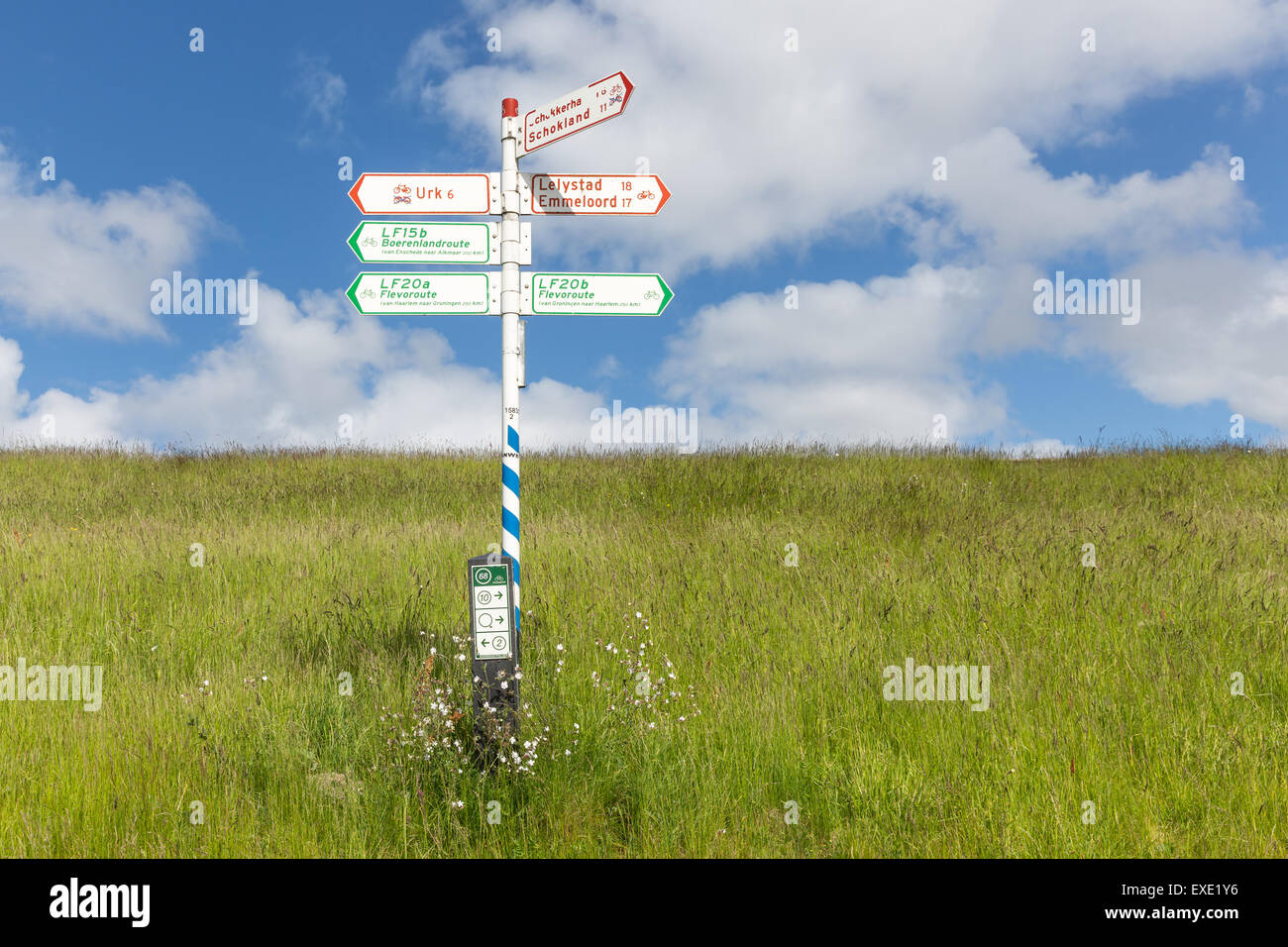 Bicycle signpost in Dutch countryside and blue sky with clouds Stock ...