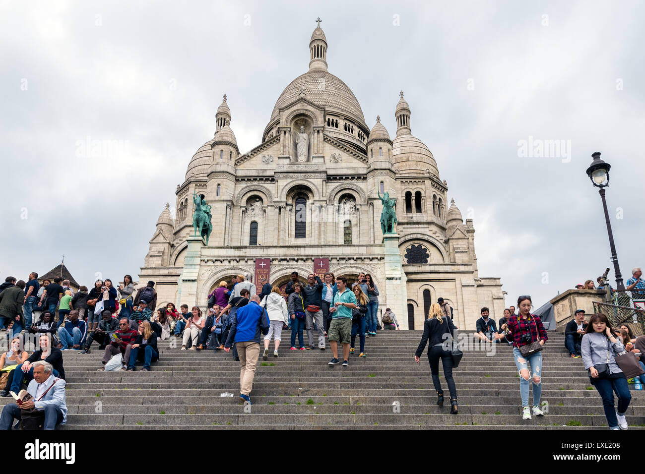 Tourists climbing the stairs of the Sacre Coeur Basilica, famous ...
