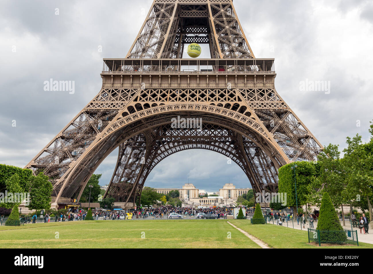 Tourists near Eiffel Tower with big tennis ball of Roland Garros in ...