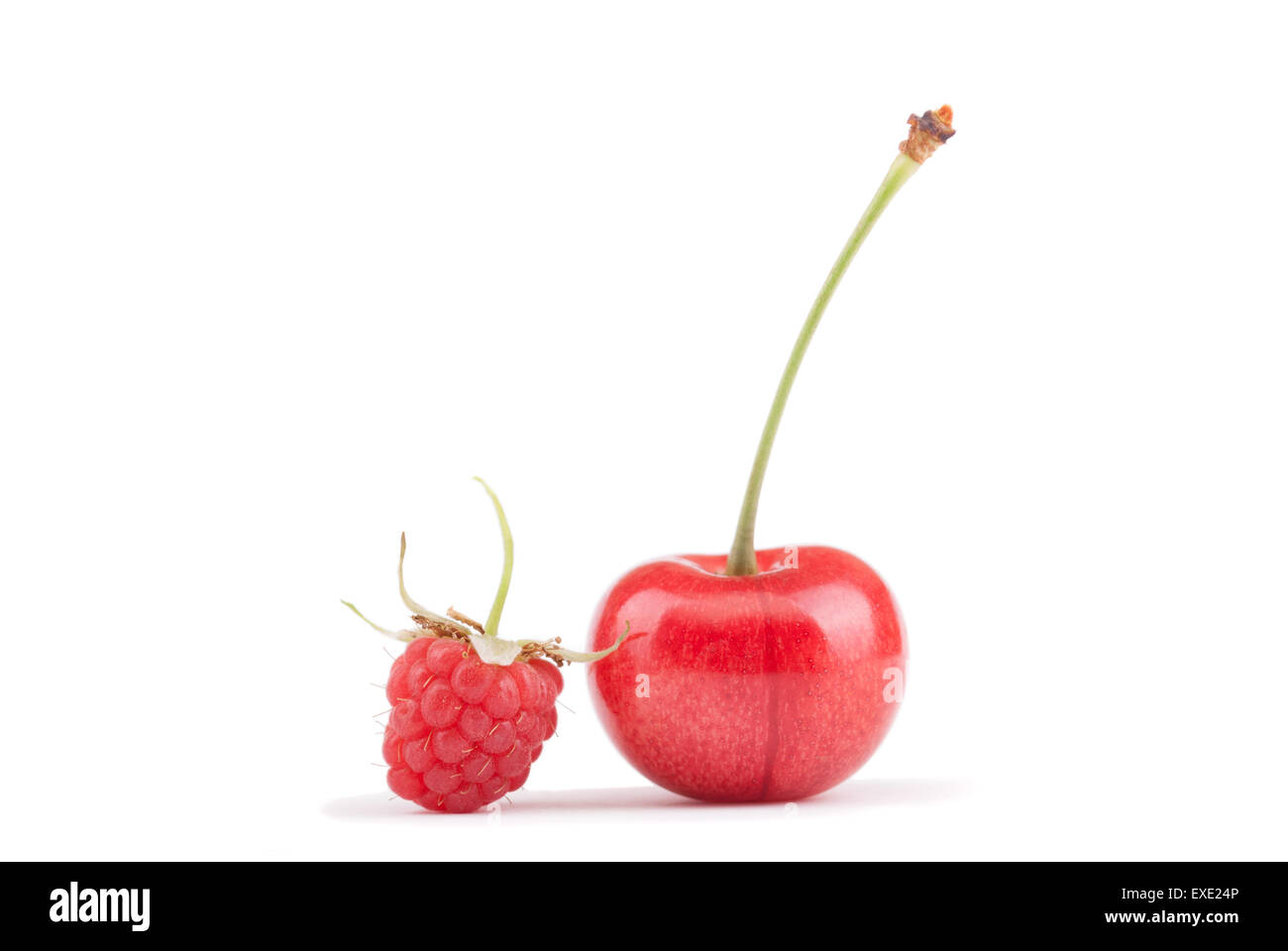 Raspberries and cherries on a white background Stock Photo - Alamy
