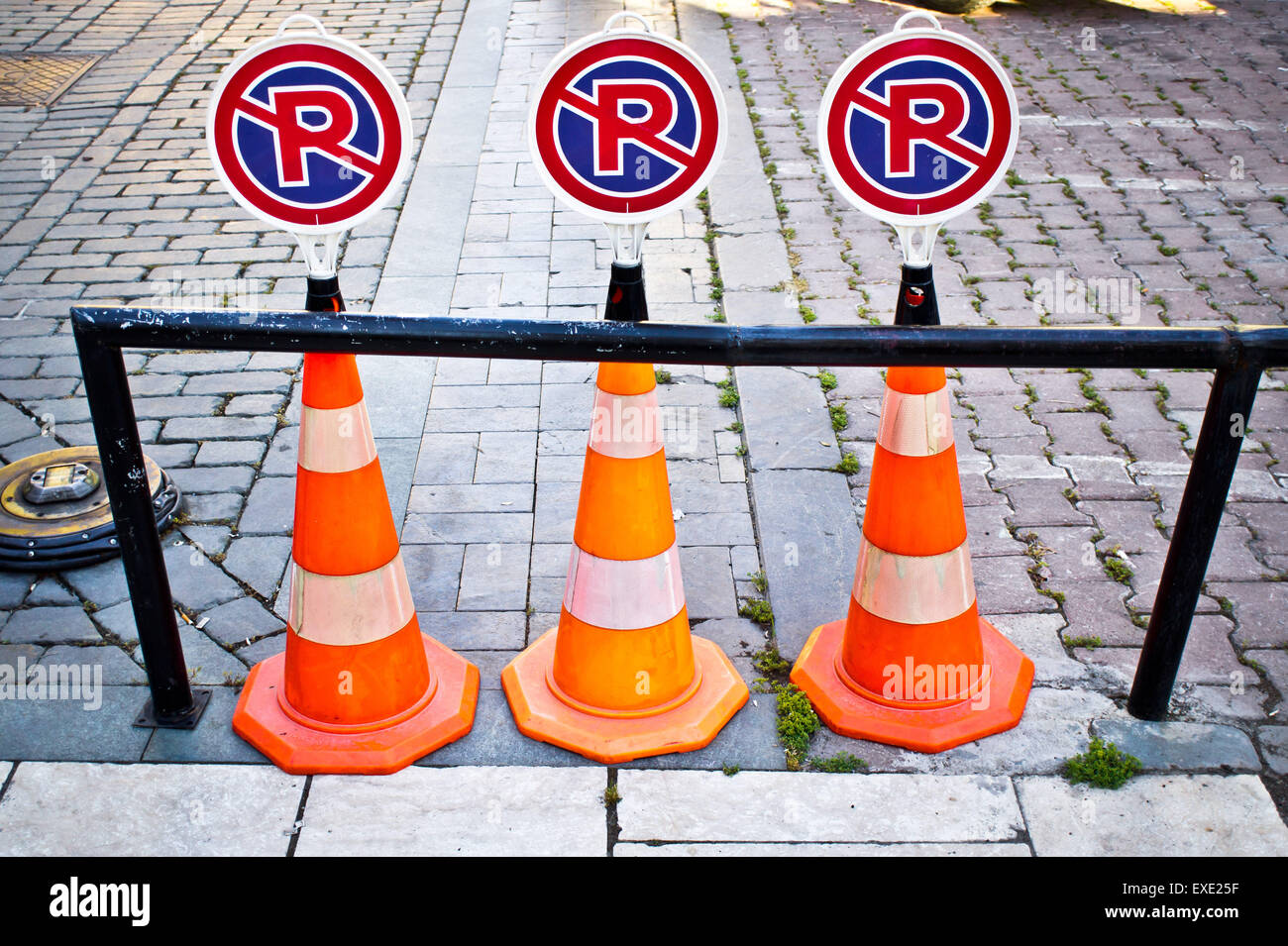 Three colorful cones in a parking area Stock Photo - Alamy