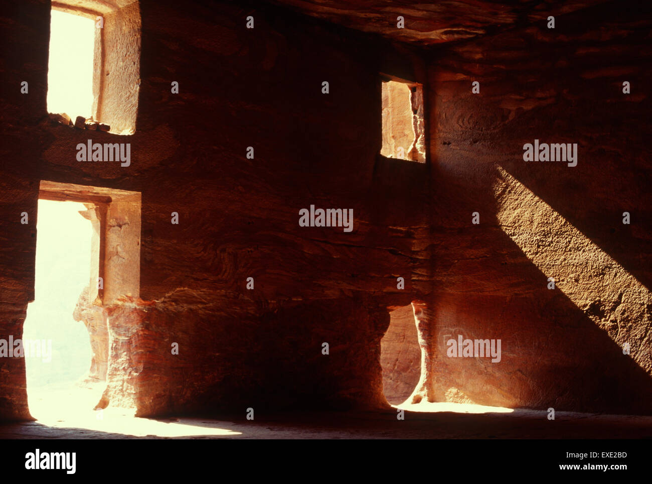 Shafts of light shine through window and door openings of the Urn Tomb ...