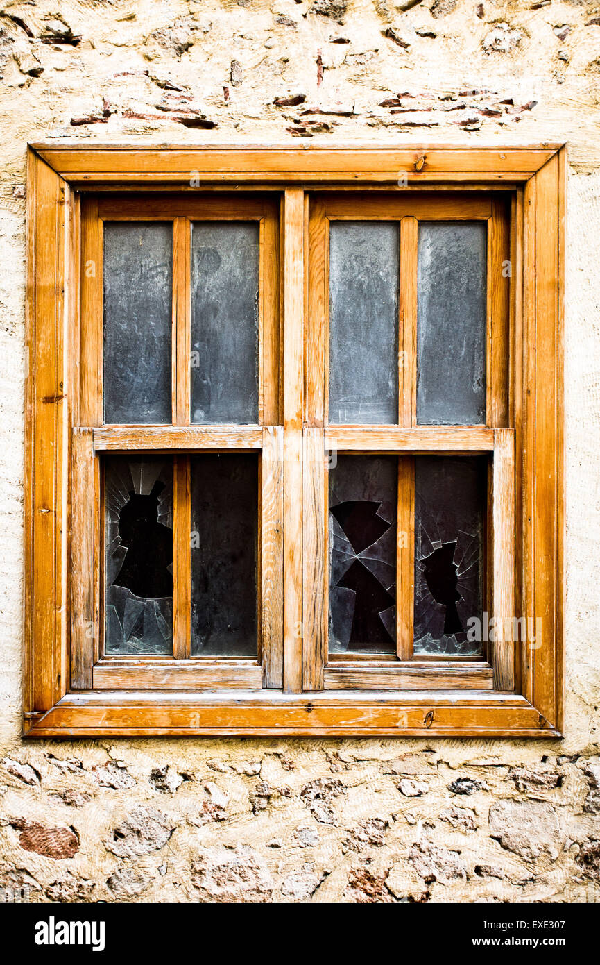 A wooden window frame with broken glass Stock Photo - Alamy