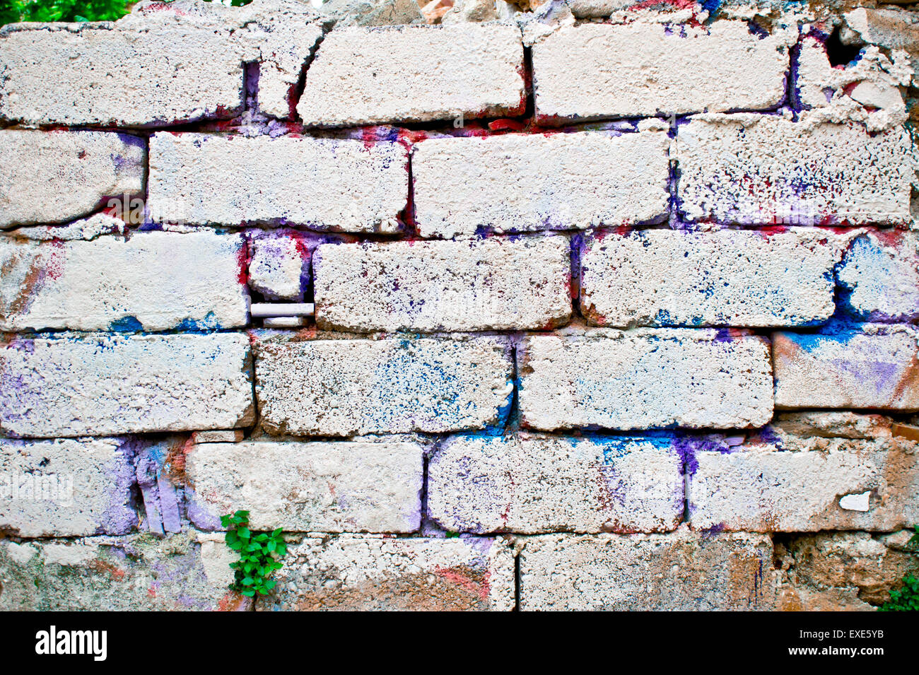 Brick wall with colorful paint marks Stock Photo - Alamy