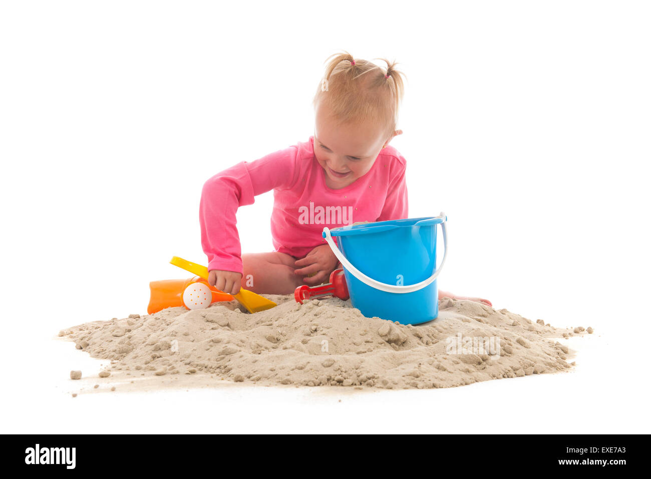 Little toddler playing in the sand isolated over white background Stock ...