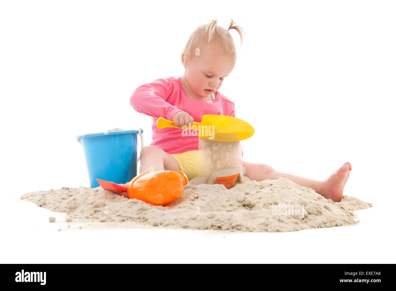 Little toddler playing in the sand isolated over white background Stock ...