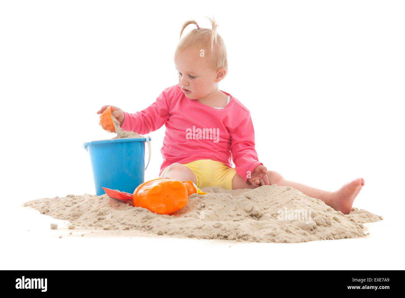 Little toddler playing in the sand isolated over white background Stock ...