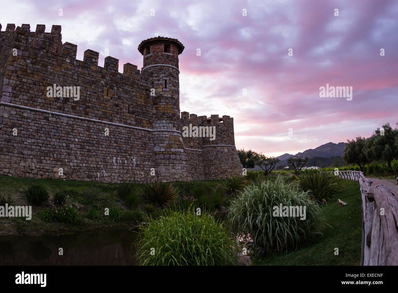 Castle in Napa Valley at sunset with a reflection on the mote Stock ...