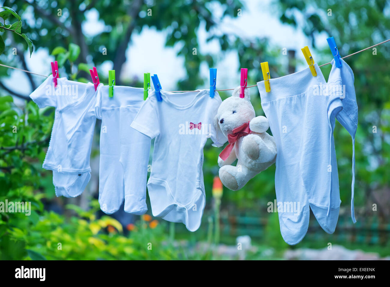 baby Clothes hanging on line in garden Stock Photo - Alamy