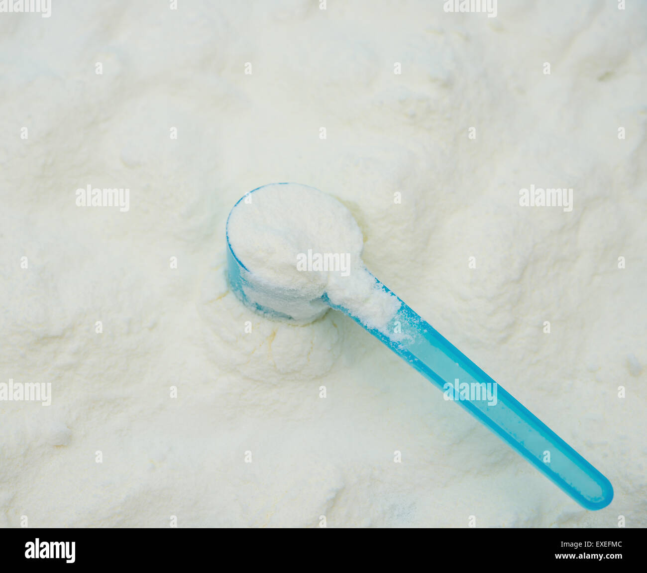 powder milk with a blue spoon Stock Photo - Alamy