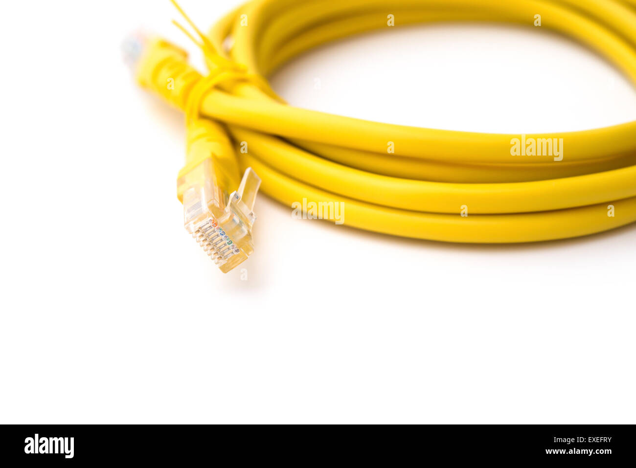 yellow RJ45 computer network connecting cable on white with clipping ...