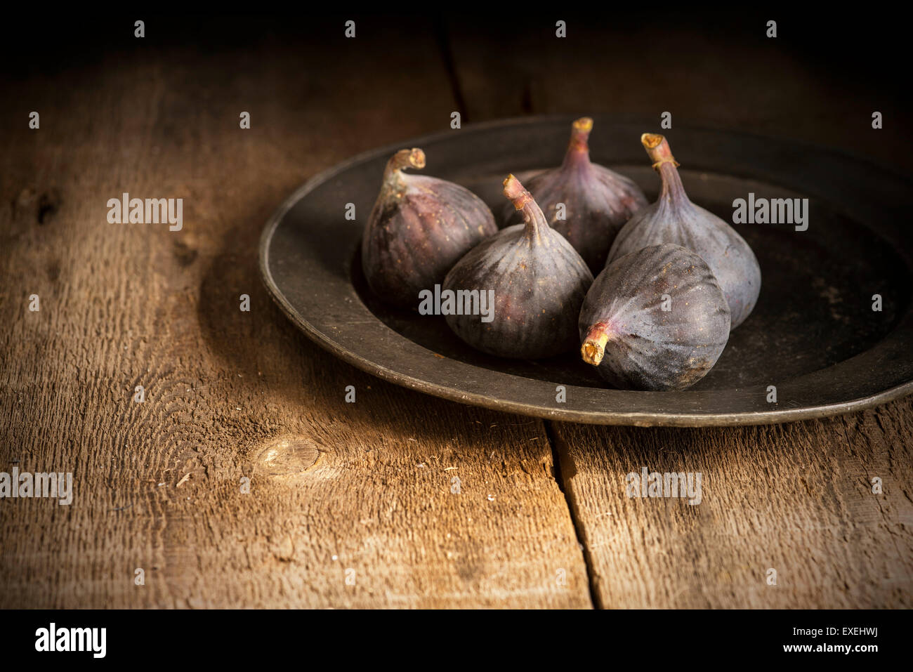 Fresh figs in moody natural lighting set with vintage style Stock Photo ...