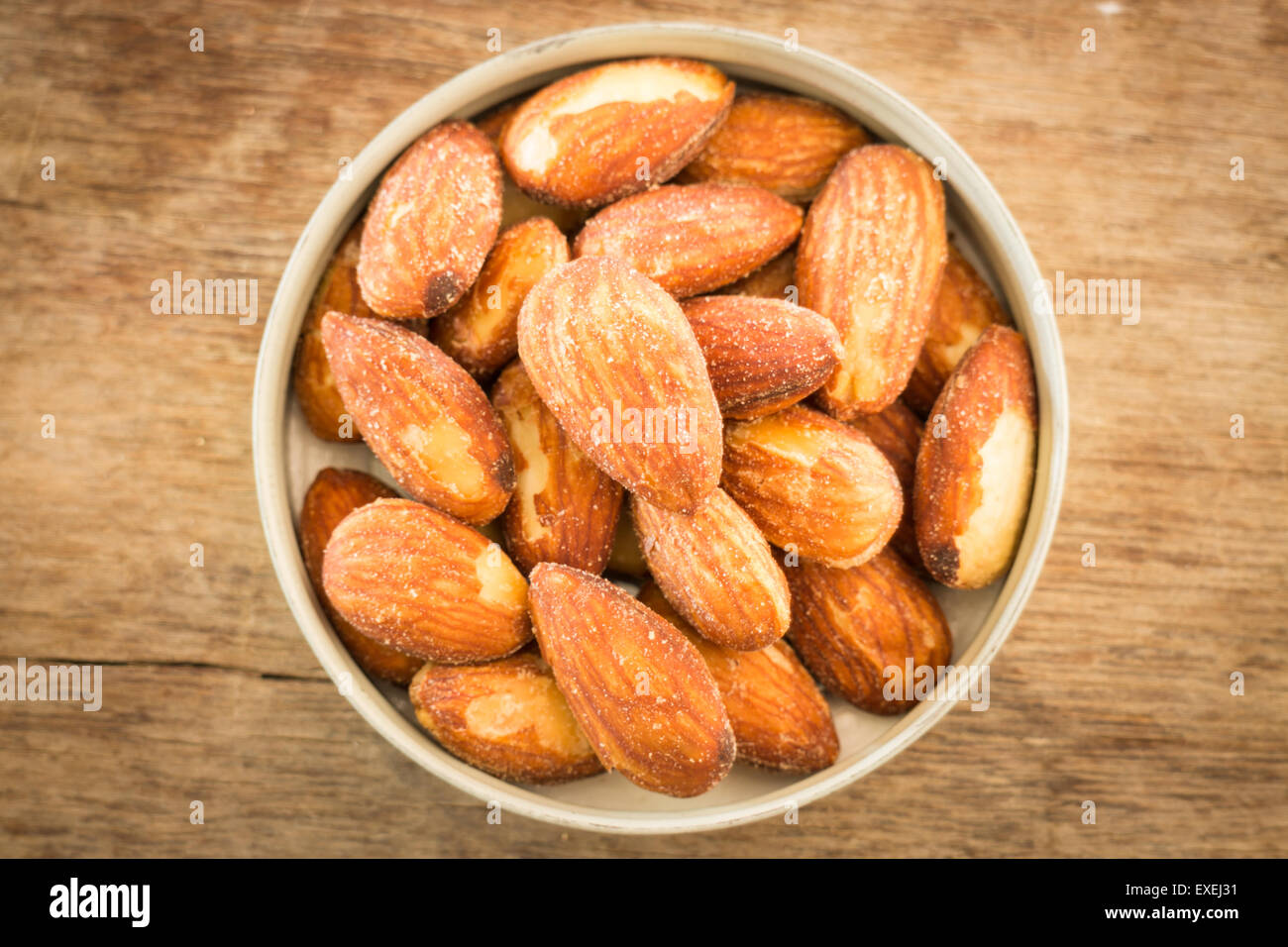 Almond grain roast salt on weathered wooden table, stock photo Stock ...