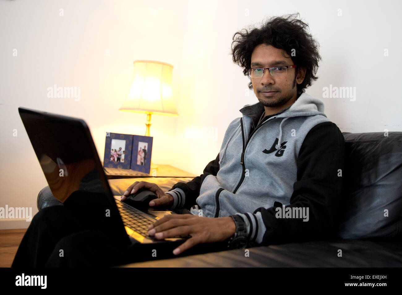 Blogger Ananya Azad from Bangladesh sits in his apartment at his laptop ...