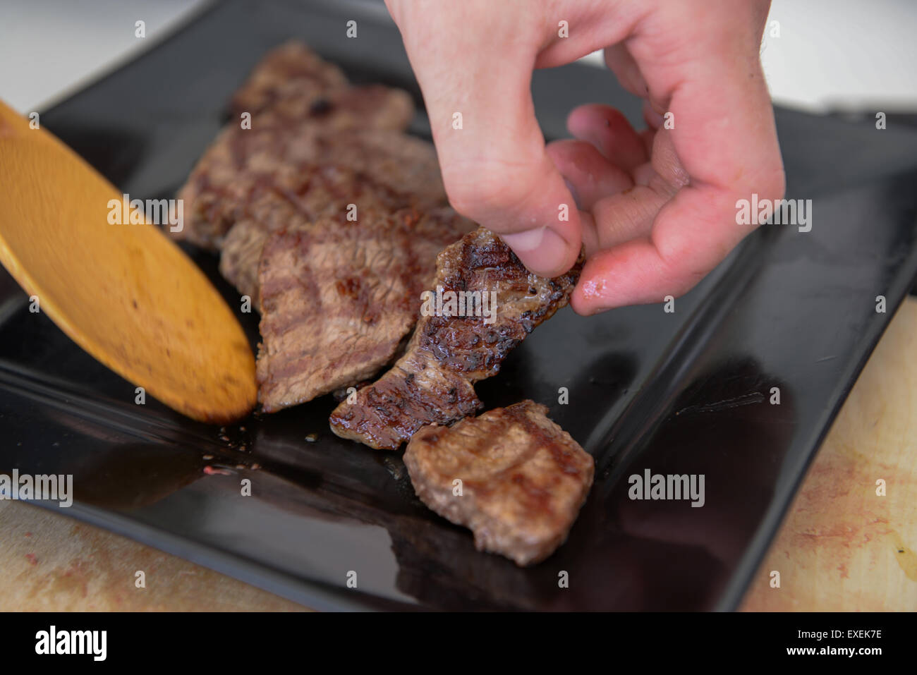 Delicious juicy steak on a black square plate Stock Photo - Alamy