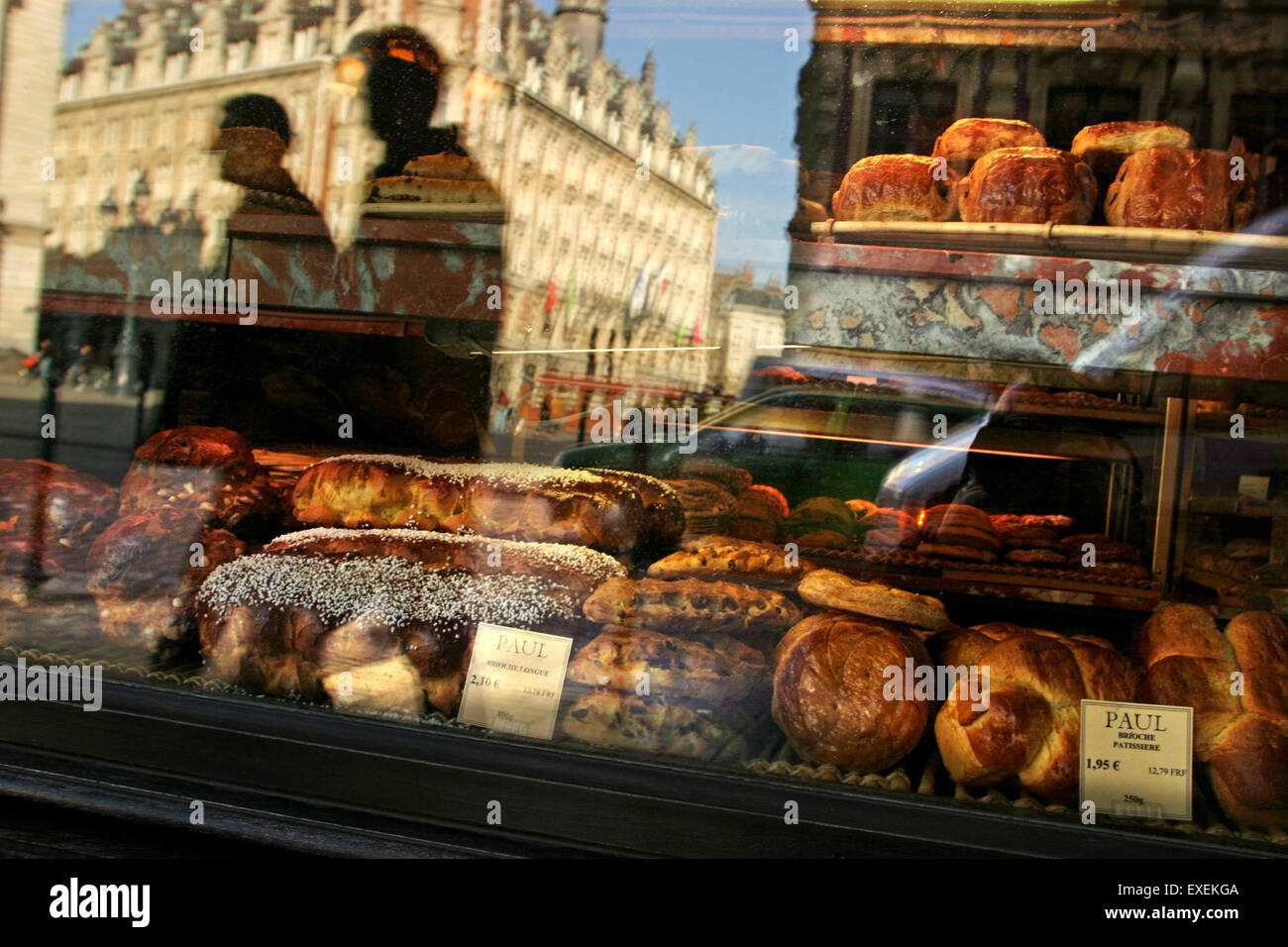 A patisserie pastry shop window with a selection of hand made loaves of ...