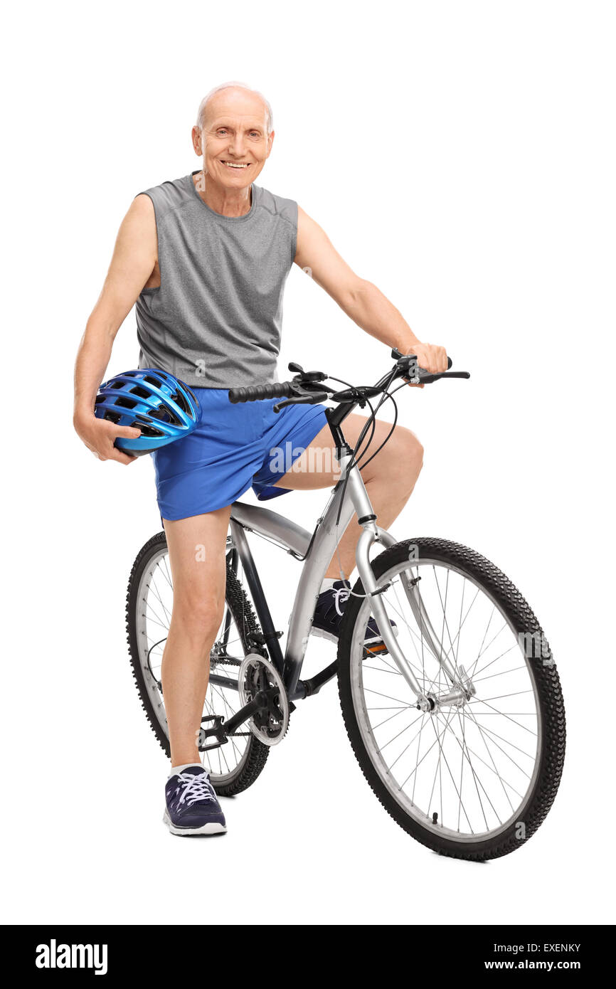 Full length portrait of a senior biker holding a blue helmet seated on ...