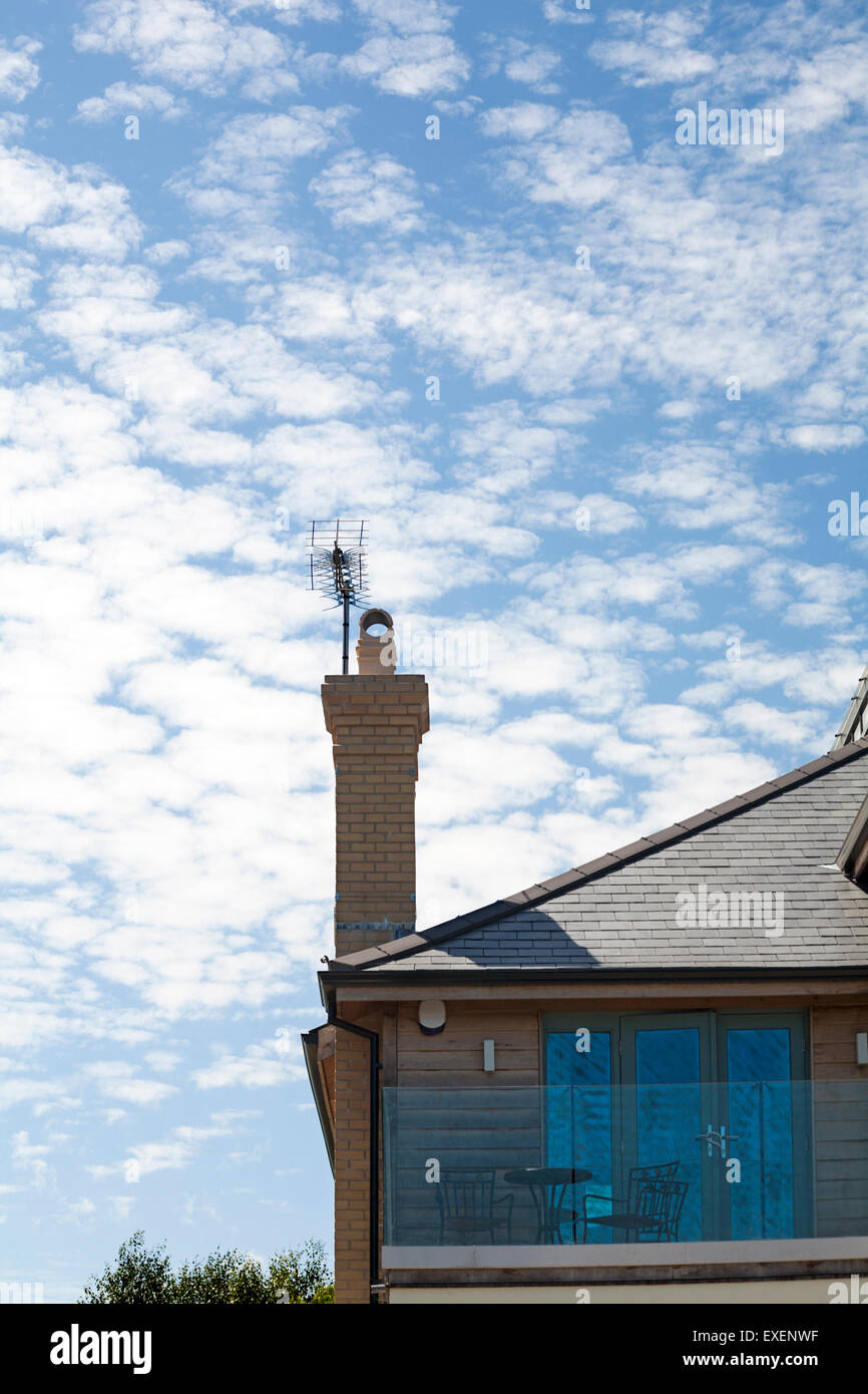 Interesting cloud patterns in the sky behind modern house with patio ...