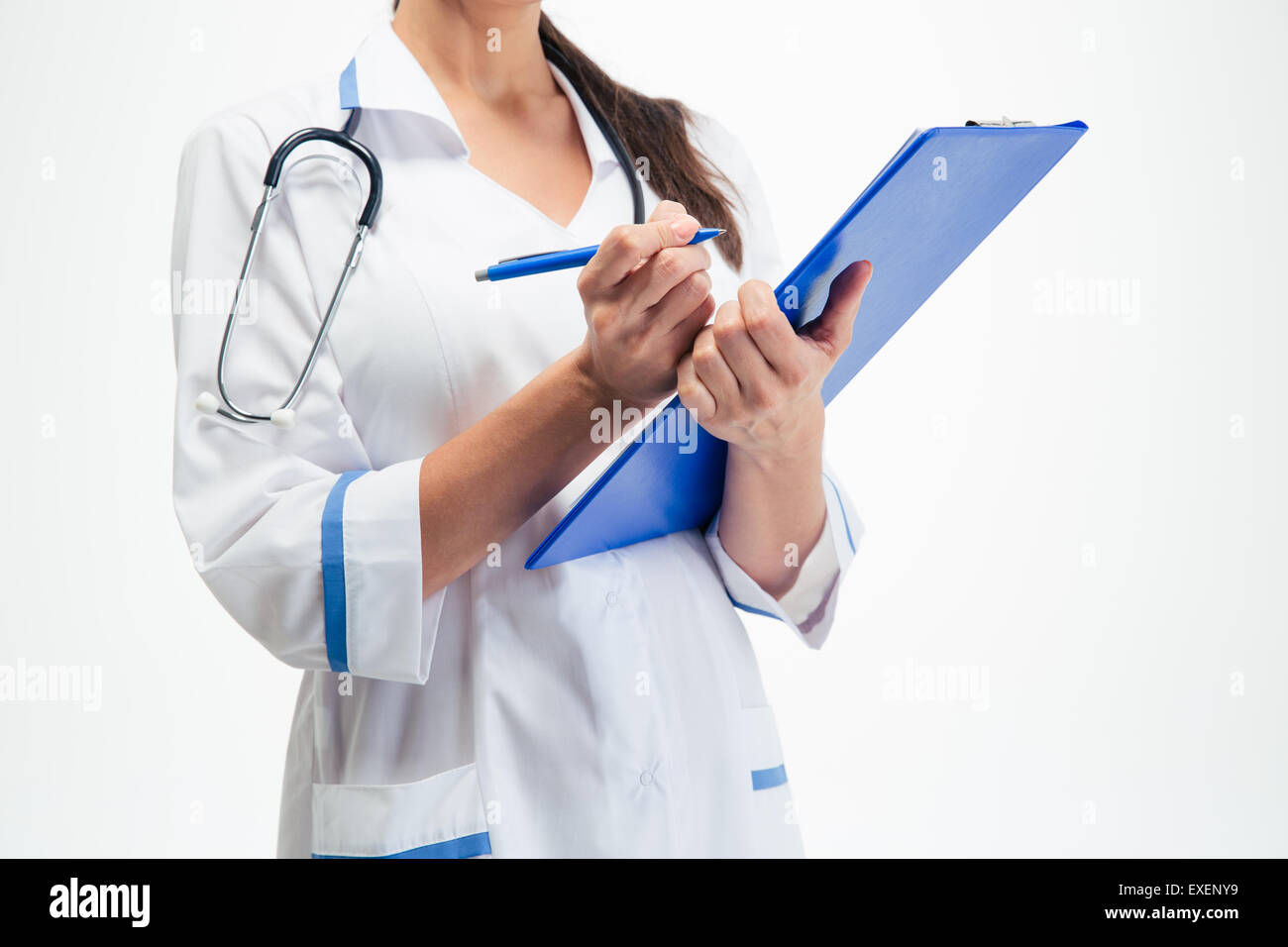 Closeup portrait of a female doctor writing notes in clipboard isolated ...