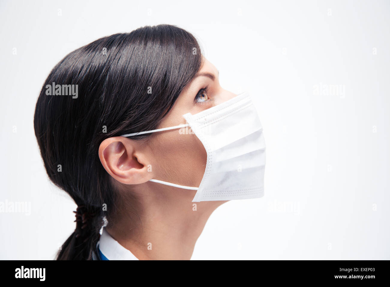 Side view portrait of a female medical doctor in mask looking up ...