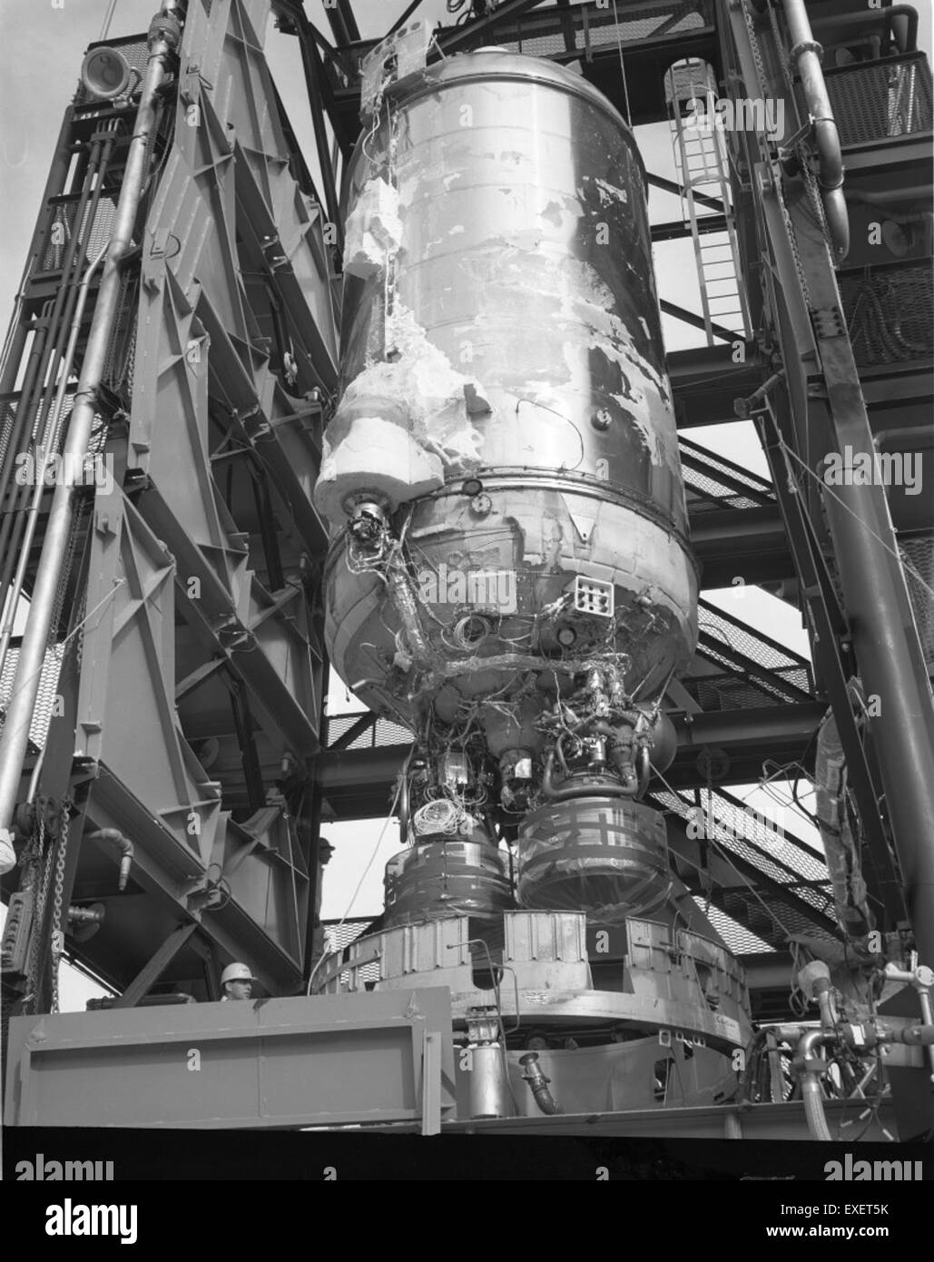 This image captures the process of lowering a tank for engine removal ...