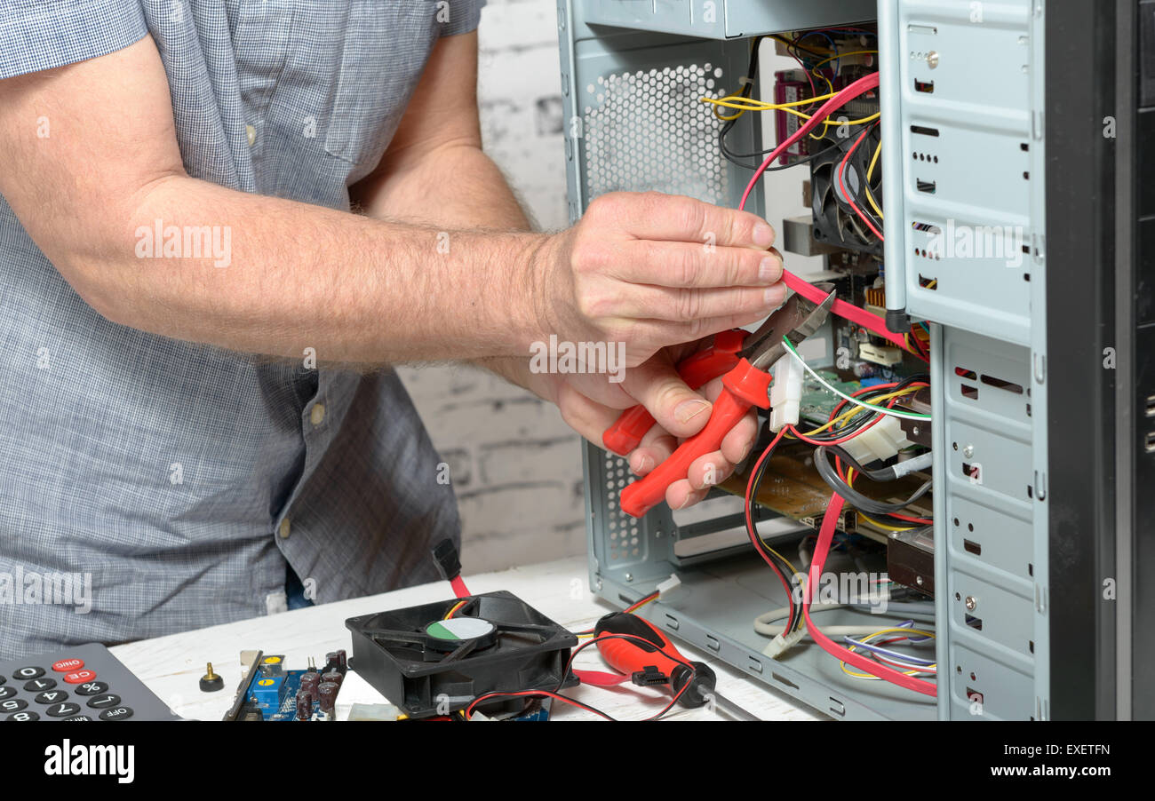 a technician repairing a computer with different tools Stock Photo - Alamy