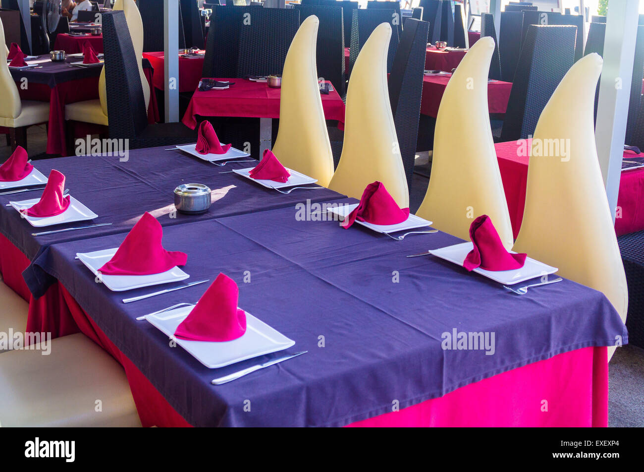 restaurant table with modern chairs shaped candle Stock Photo - Alamy