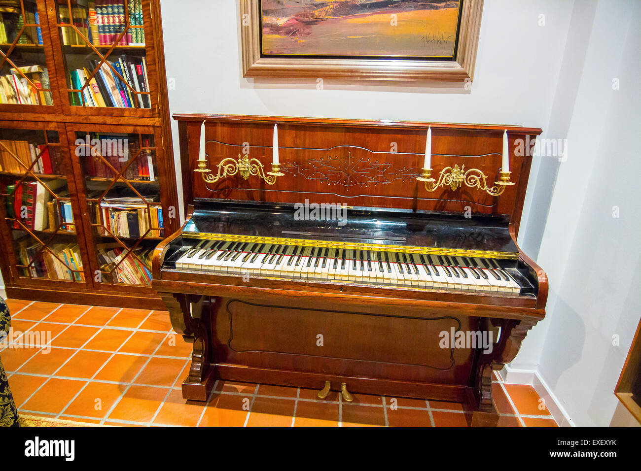 antique piano with ivory keys and old chandeliers to illuminate Stock ...
