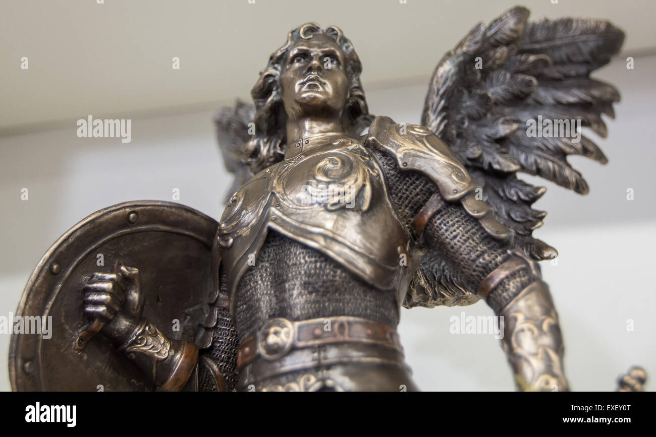 Angel sculpture with shield and wings Stock Photo - Alamy