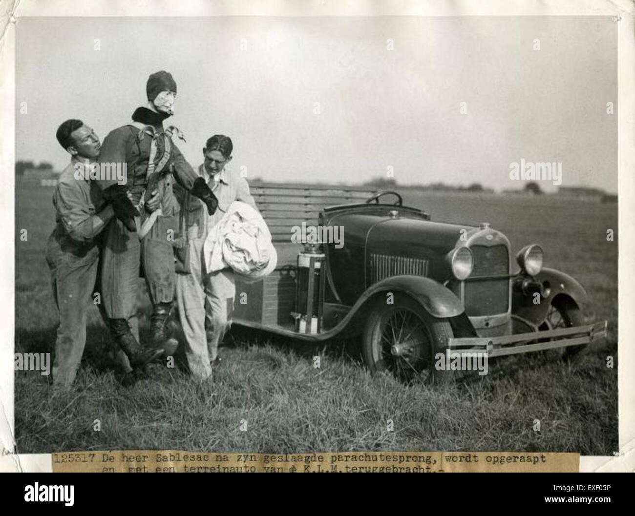 The image depicts a successful parachute jump with a crash test dummy ...