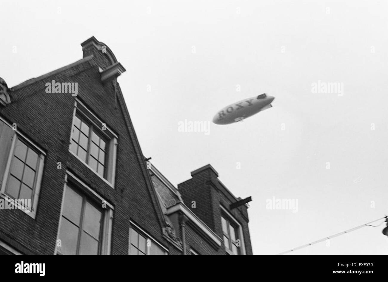A commercial zeppelin flying above Amsterdam, showcasing advertising on ...