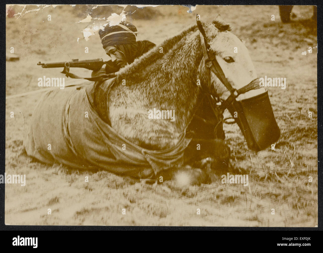 This image shows a soldier with a rifle taking cover behind a fallen ...
