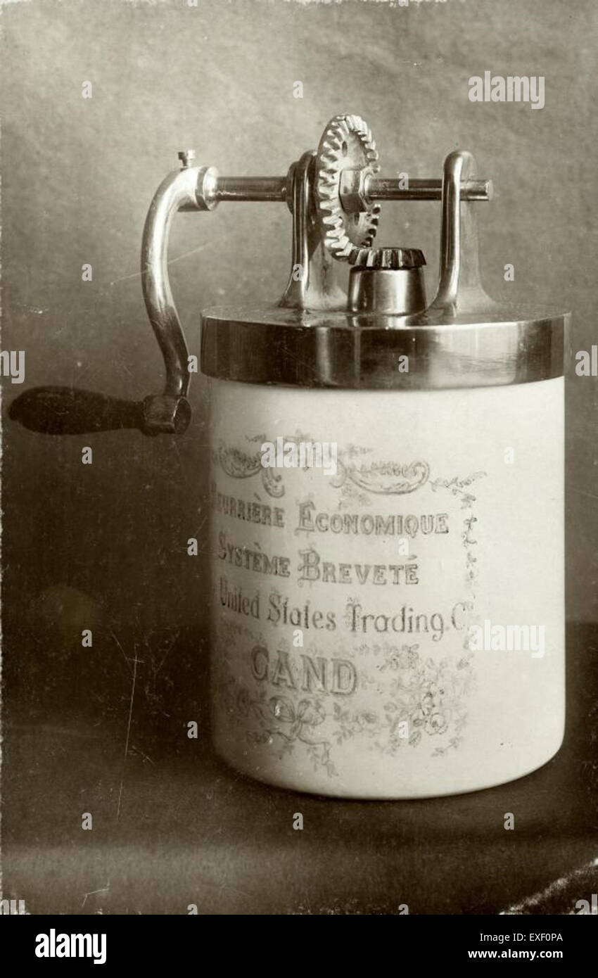 A vintage table model butter machine, used for churning butter on a ...