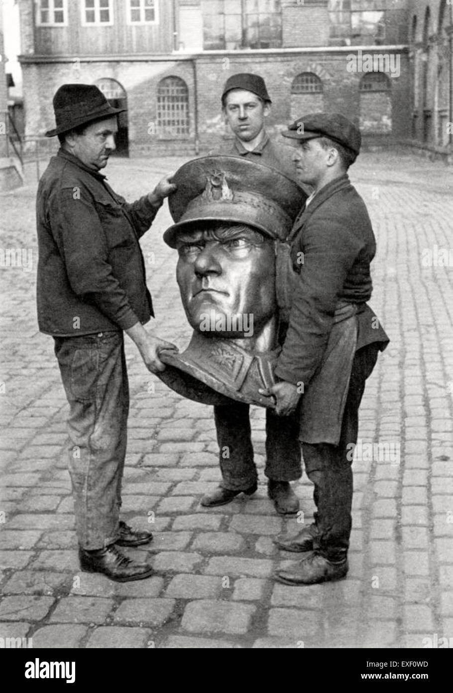 A historical photograph of Turkish workers with a bronze bust of ...